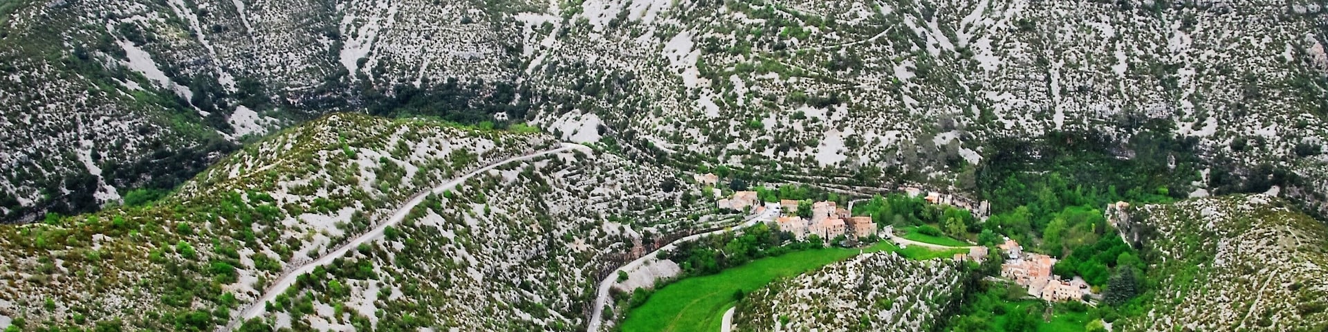 This stunning location is one of the deepest valleys in Europe. You can see the road leading down and it zig-zags up the other side. There's a small village at the bottom but there's a cafe on one lookout that has a wonderful view over this scene. Definitely worth a look if you're in the area.