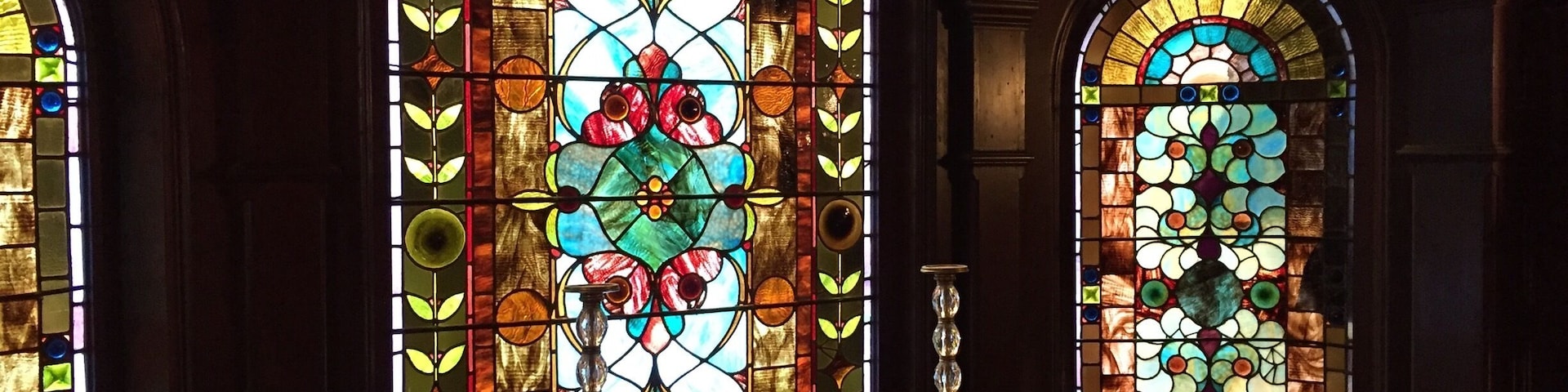The organ and stained glass windows on the landing between the first and second floors.
