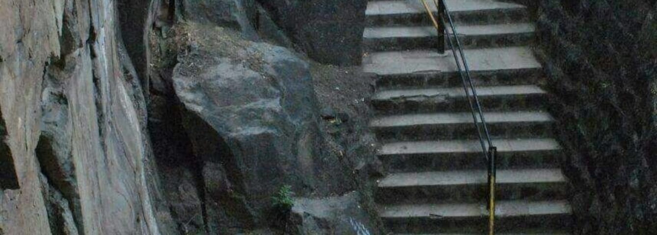 Steps going towards cave. To reach here one has to travel on rough road by vehicle for 3kms & one km walk up on hills.