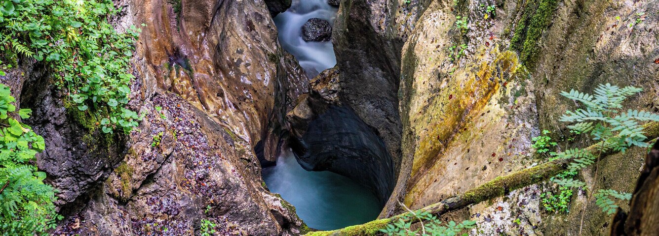 Deep gorge with crystal clear turquoise water. Reminded me a lot of Mistaya Canyon in Banf National Park in Canada.