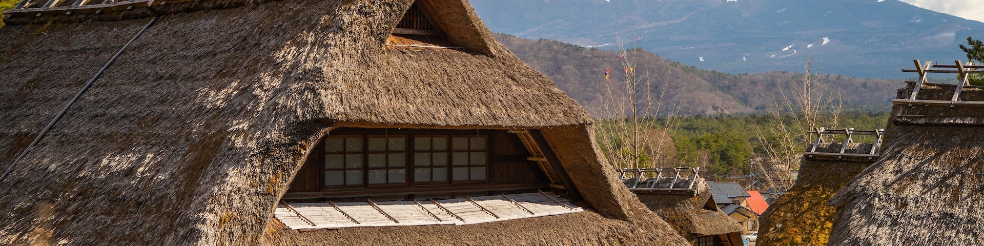 Lake Saiko Iyashi no Sato NENBA showing snow, a small town or village and mountains