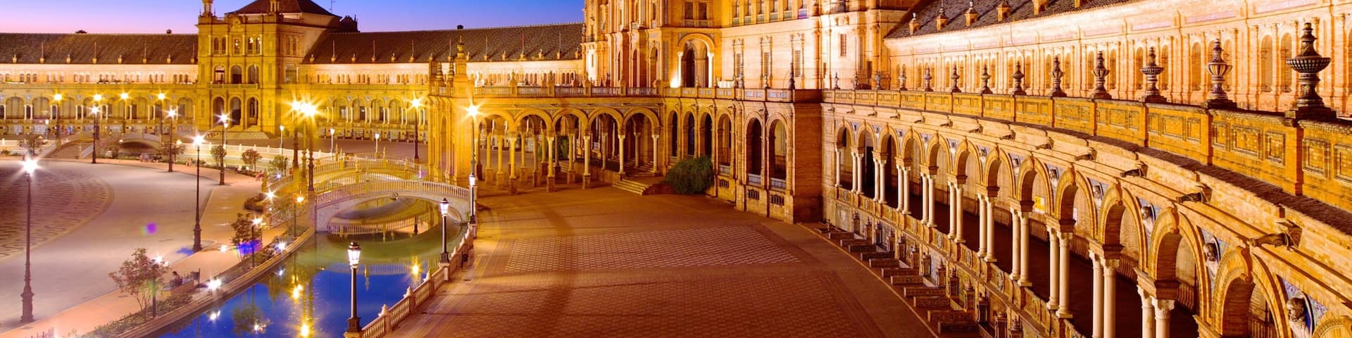 Plaza de Espana which includes a castle, heritage architecture and night scenes