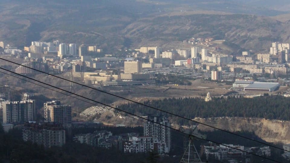 Newly re-opened aerial tram. View from the city of Tbilisi.
The Georgian capital of Tbilisi used to be home to an intricate system of aerial trams, that whisked people from lower elevations to the various hilltops around the city.
Most of these trams fell into disrepair following the collapse of the Soviet Union. One of these old tram stations recently re-opened. This tram connects Vake Park with the small Turtle Lake, which is located on a hillside above.
You can even attach your bicycles to the tram (as is visible in this picture).