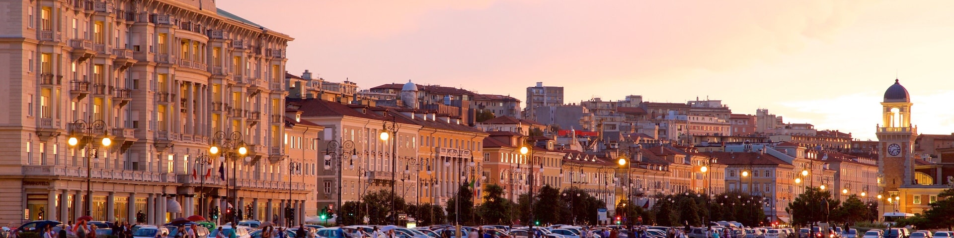 Trieste featuring general coastal views, a sunset and heritage architecture