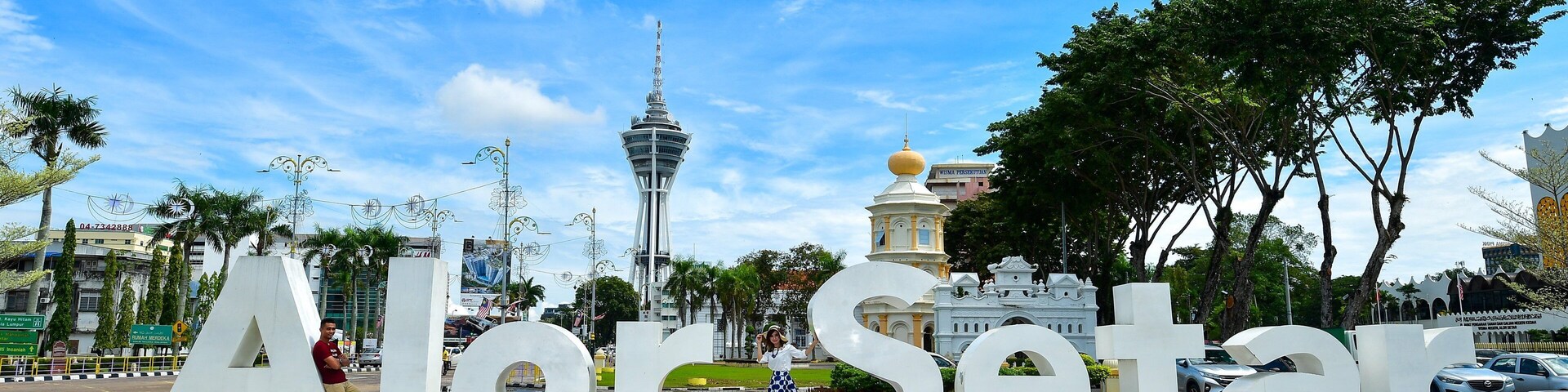Alor Setar showing a square or plaza and signage as well as an individual femail