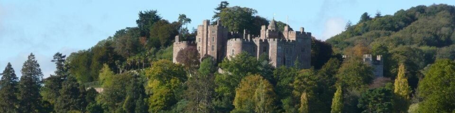 This is Dunster Castle, near Minehead in North Somerset. This is the view you get as you approach, and I just think it's such a beautiful sight, rising up out of the trees. There's an ancient castle, plus a more modern (as in 17th century modern) Manor House. The last residents gave it to the National Trust to look after. Dunster Village is also very pretty and worth a little wander through.