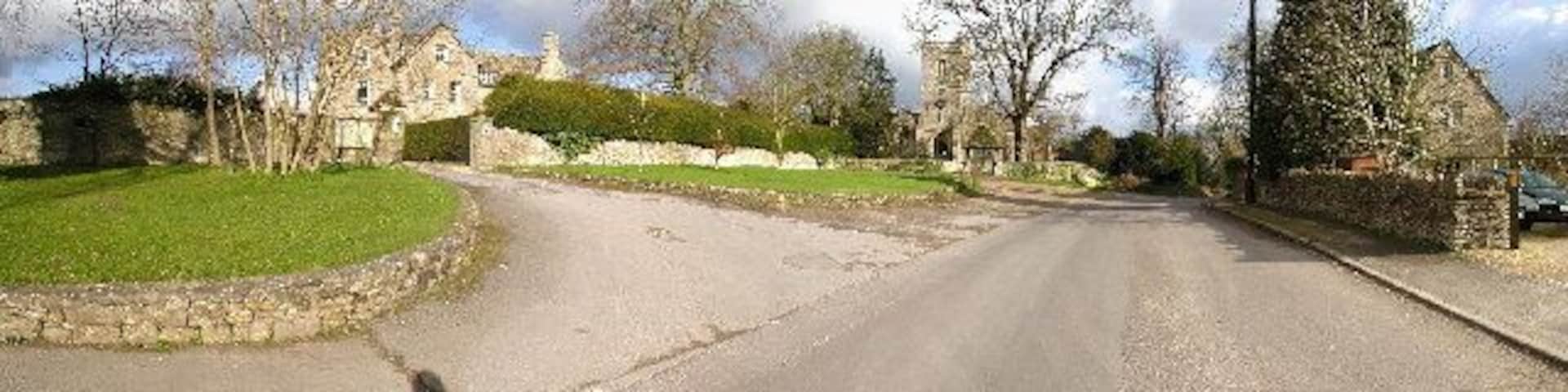 Approach to All Saints Church, Crudwell. I think the building on the left is the Old Rectory Country House. The ancient church straight ahead is All Saints Church. This is the view that you get as you leave the main road coming from The Mayfield House Hotel.