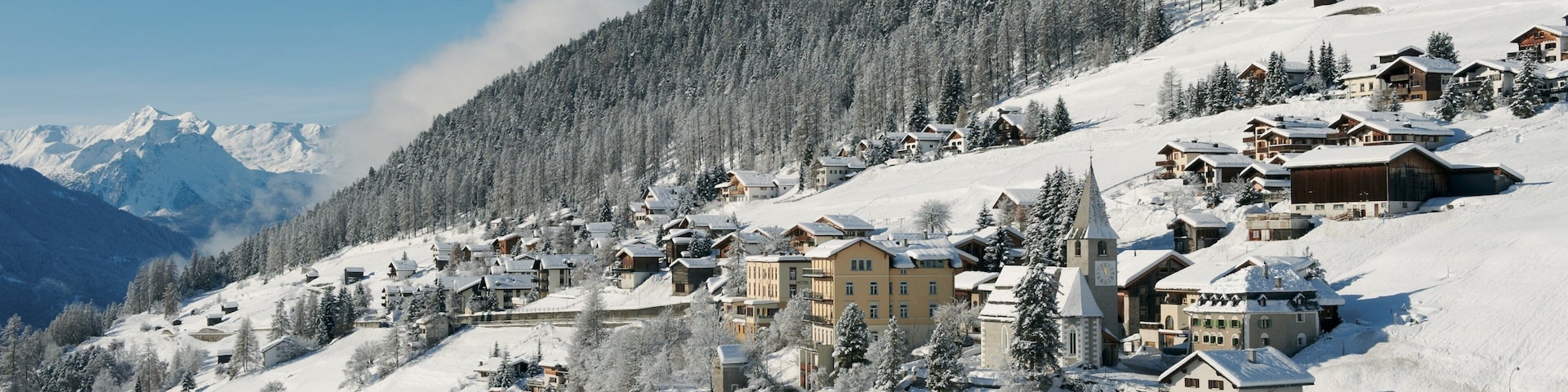 Davos which includes mountains, snow and a small town or village