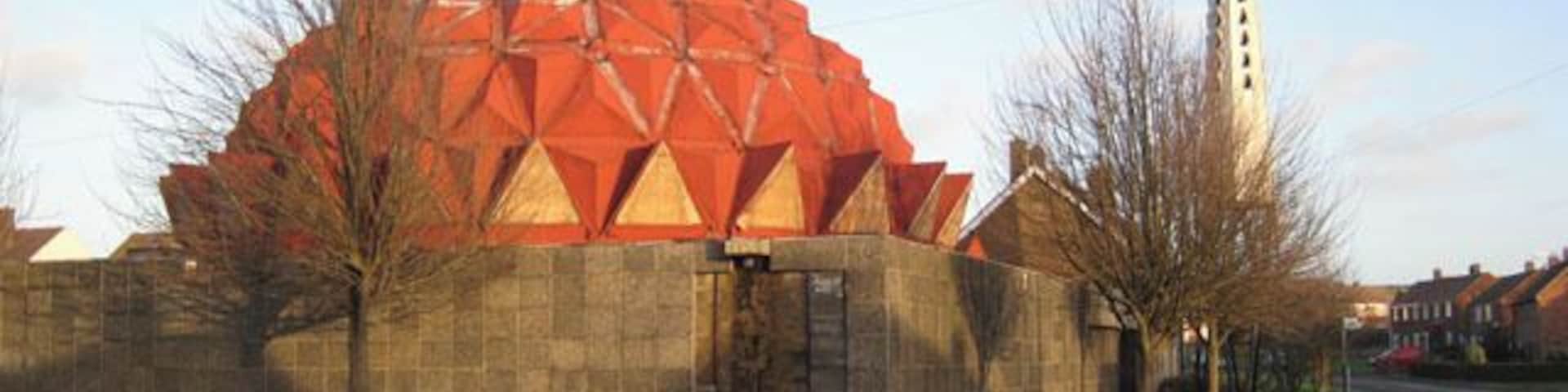 Church of Christ the King, Bowburn. Oliver Dixon writes at Geograph: "Built in 1976, this striking futuristic church stood in the former mining village of Bowburn. Unfortunately, it suffered serious design faults and was closed in September 2004. At the time of photography the building was in a sorry state with the roof in a poor state of repair, and the whole premises fortified like Fort Knox against vandals. The building was demolished in May 2007, just leaving the cross standing." Update taken from the website www.christthekingchurch.co.uk The Church of Christ the King is the Parish Church (C of E) serving the three villages of Bowburn, Cassop and Quarrington Hill with members of the congregation drawn from all three villages and beyond. A new multi purpose church building and hall was dedicated, after enormous efforts from the congregation, in September 2008, on the site of the old building (once famous in the area as 'the pineapple church'). Worship is in the Catholic tradition of the Church of England within which all are welcome and made to feel at home. The Bishop of Beverley (the Provincial Episcopal Visitor for the Northern Province), the Rt. Revd. Glyn Webster has pastoral and sacramental care of the parish, which is in the Diocese of Durham. The celebration of the Mass (Eucharist or Holy Communion) is at the centre of the parish's worshipping life both on Sundays and in the week. Morning or Evening Prayer is also said daily (Mondays excepted) by the parish priest with others and all are welcome to join in. During the Sunday Mass a small but active Sunday School meets in the hall. On Thursday evenings our parish branch of the Church Lads and Church Girls Brigade, a uniformed organisation for young people aged 5 and upwards, meets in the Church Hall. There is a very active programme of social and fundraising events: fairs, quizzes, suppers etc., normally once a month at which all are welcome. The church hall is available for hire for one off or regular functions normally at £11 per hour. Bookings for Baptisms, Marriages, Banns etc. can normally be made at church on a FRIDAY 5.30PM-6PM. Full details of weekly services, socials and special events can be found on the weekly news sheet or on the notice board outside church.