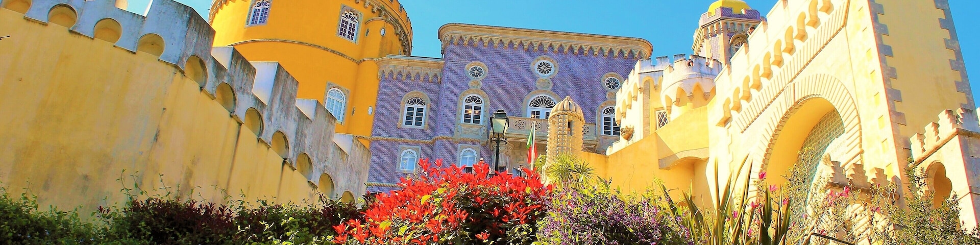 I took this in March in Sintra, Portugal! It's at the fairy tale castle Pena Palace :). This is one of the lovely close-up views. It's is a Romanticist castle that stands on the top of a hill in the Sintra Mountains. And undoubtedly one of the most iconic places in Portugal. And a dream come true to visit it! It is a national monument and constitutes one of the major expressions of 19th-century Romanticism in the world. The palace is a UNESCO World Heritage Site and one of the Seven Wonders of Portugal. It is also used for state occasions by the President of the Portuguese Republic and other government officials. Thanks to Wikipedia for help ;).
