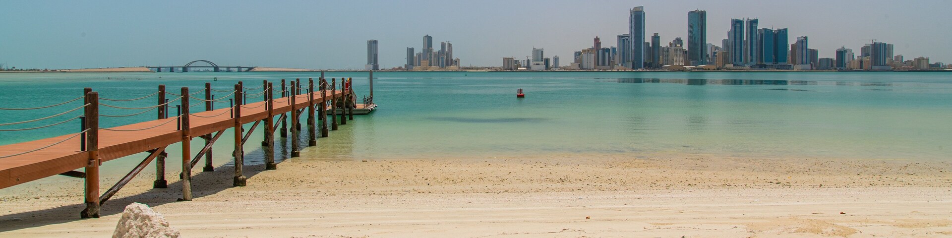 Manama showing a beach and general coastal views