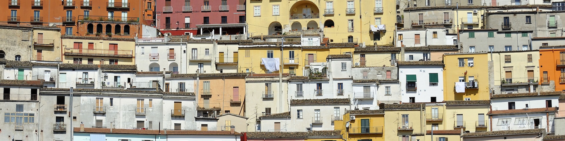 Uma encosta densamente povoada por edifícios coloridos, com varandas e terraços.