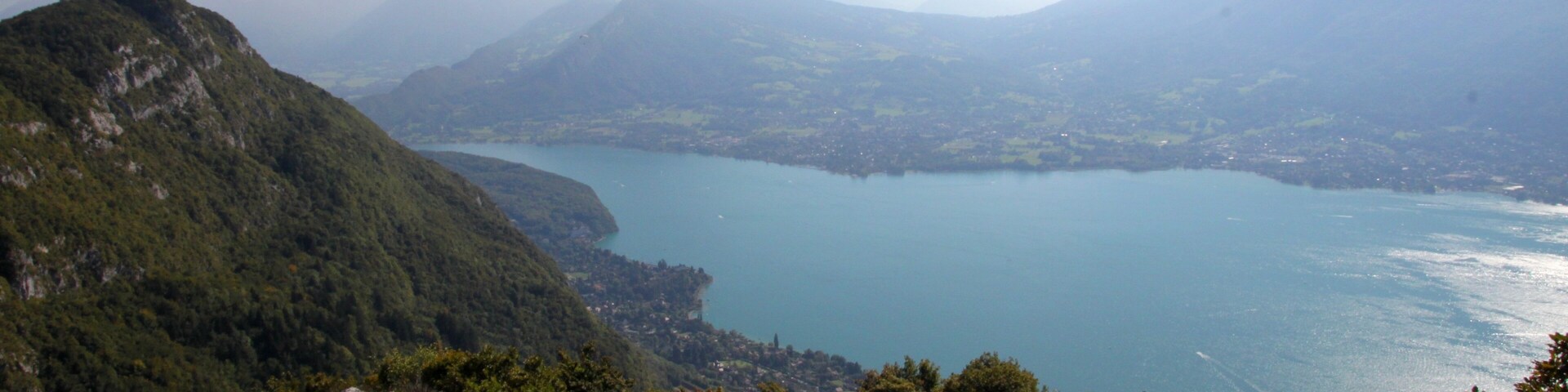 Paisagem montanhosa com um lago e uma cidade.