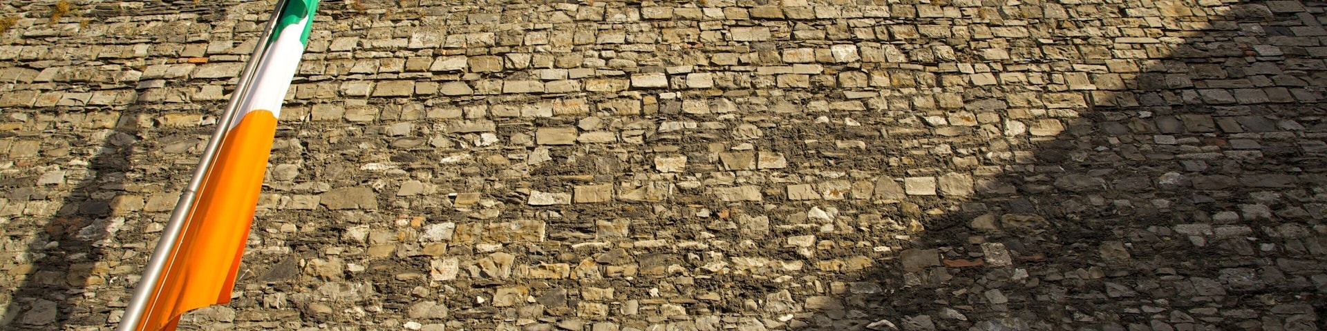 Kilmainham Gaol Historical Museum showcases Ireland's revolutionary history with its iconic walls and vibrant flag
