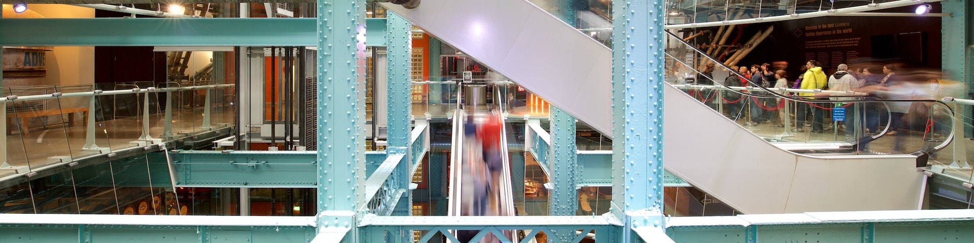 Guinness Storehouse que inclui arquitetura moderna e vistas internas assim como um pequeno grupo de pessoas