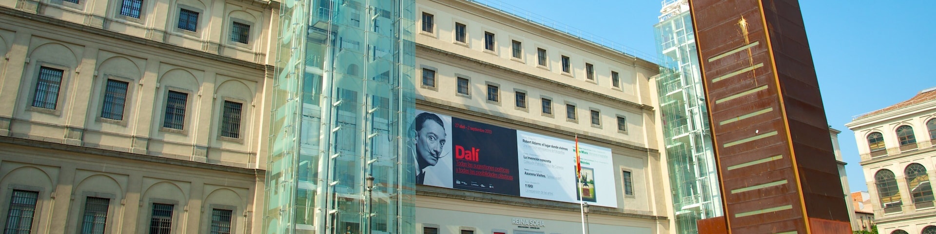 Reina Sofia Museum which includes a square or plaza and modern architecture as well as a large group of people