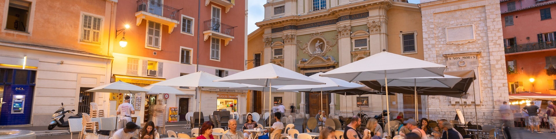 Nice Cathedral showing a city and outdoor eating as well as a small group of people