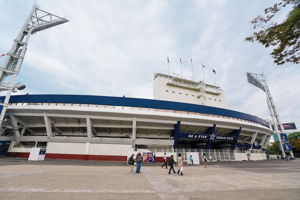 A large stadium with a blue and white color scheme, featuring the text "BE A STAR DREAM GATE" and "YOKOHAMA".