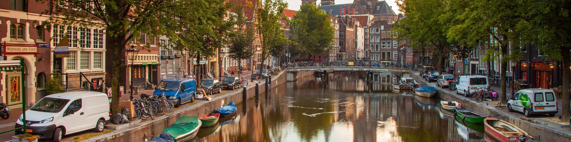 Red Light District showing a city, a river or creek and a sunset