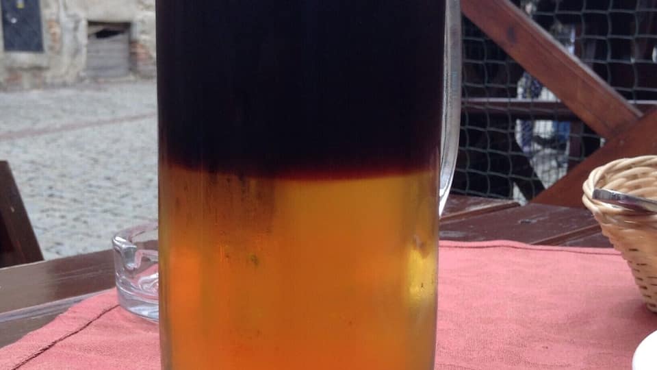 Rezane is beer that is half dark / half light, and can come as two layers (like this), or completely mixed.
It can be found throughout Slovakia, Czech Republic, and Poland (and maybe a few other countries) - although may not be always on the menu.
Definitely worth trying if you have the chance.