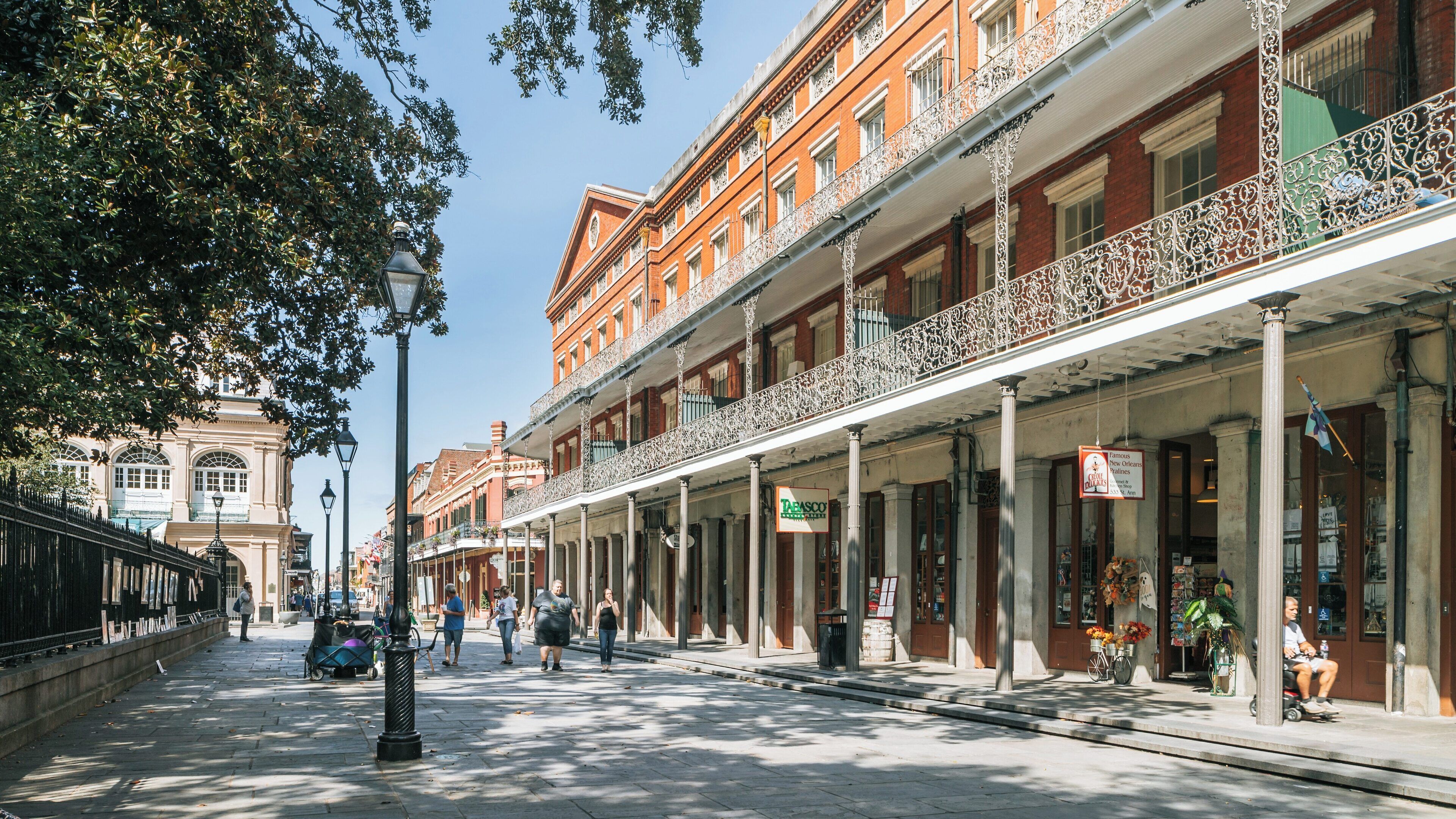 Explore Jackson Square in the French Quarter of New Orleans surrounded by vibrant activities and historic architecture during a sunny day