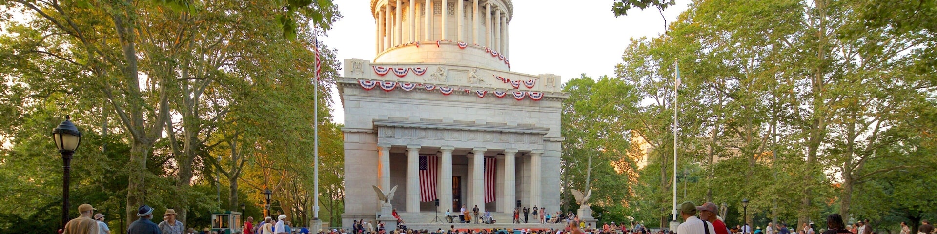 Riverside Park featuring heritage architecture and a square or plaza as well as a large group of people