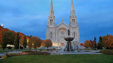 Uma catedral com duas torres altas, uma rosácea central e uma fonte em primeiro plano.