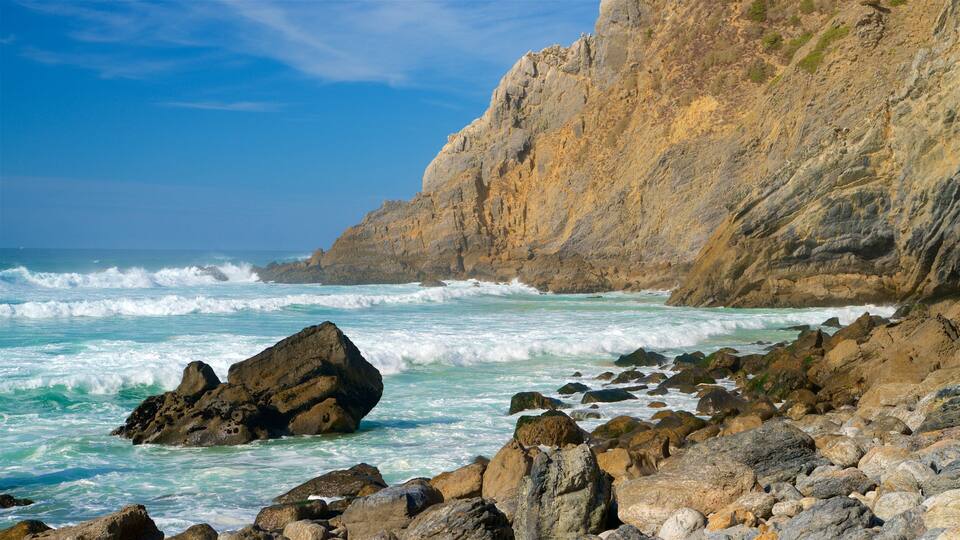 Adraga Beach featuring rocky coastline, waves and general coastal views