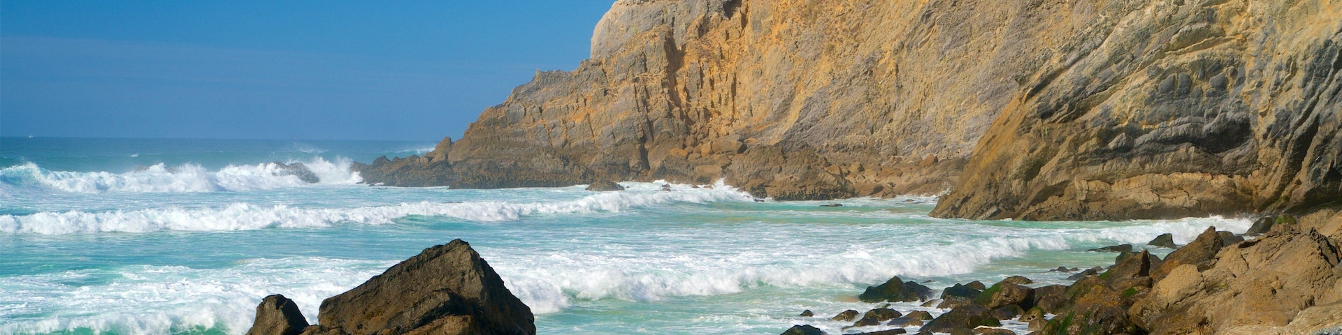 Adraga Beach featuring rocky coastline, waves and general coastal views