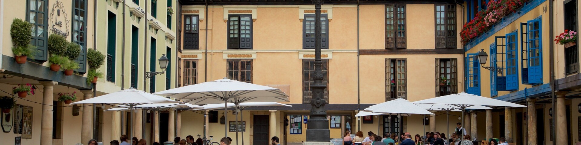 Plaza del Fontán mostrando jantar ao ar livre e cenas de rua assim como um pequeno grupo de pessoas