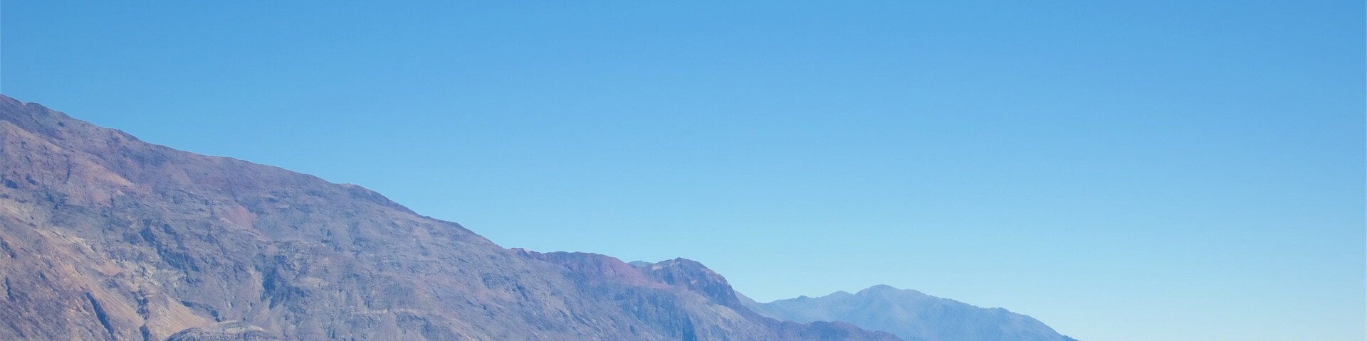 Devil\'s Golf Course featuring desert views and landscape views as well as a small group of people