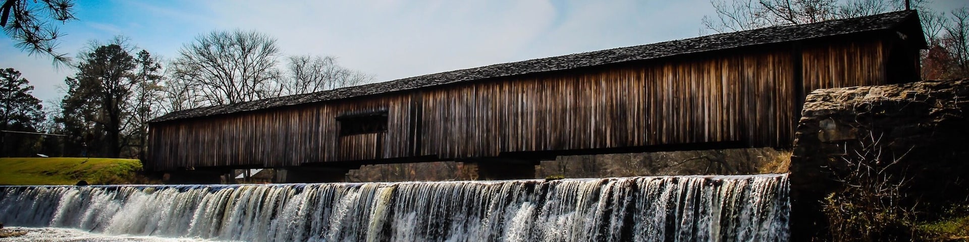 One of the most picturesque state parks in Georgia, Watson Mill Bridge contains the longest covered bridge in the state, spanning 229 feet across the South Fork River. Built in 1885 by Washington (W.W.) King, son of freed slave and famous covered-bridge builder Horace King, the bridge is supported by a town lattice truss system held firmly together with wooden pins. At one time, Georgia had more than 200 covered bridges; today, less than 20 remain