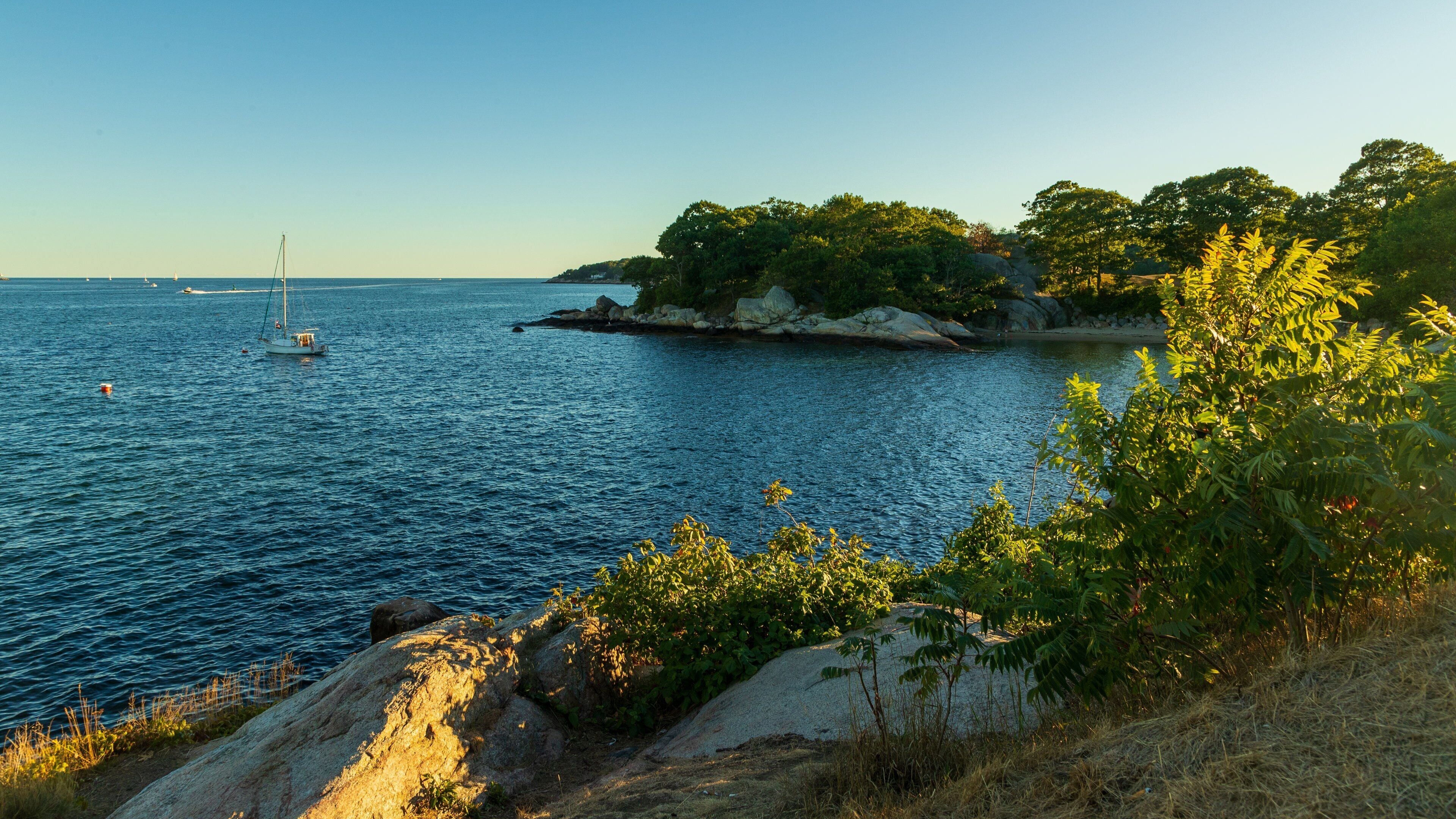Stage Fort Park which includes a sunset, landscape views and general coastal views