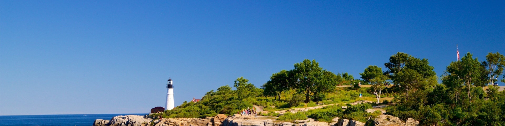 Fort Williams Park featuring a lighthouse, rugged coastline and general coastal views