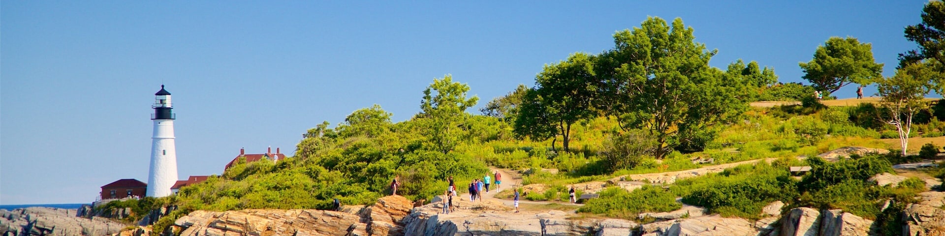 Fort Williams Park which includes rocky coastline, a lighthouse and general coastal views