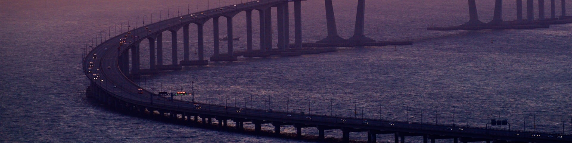 Incheon Bridge featuring a sunset, a bridge and landscape views