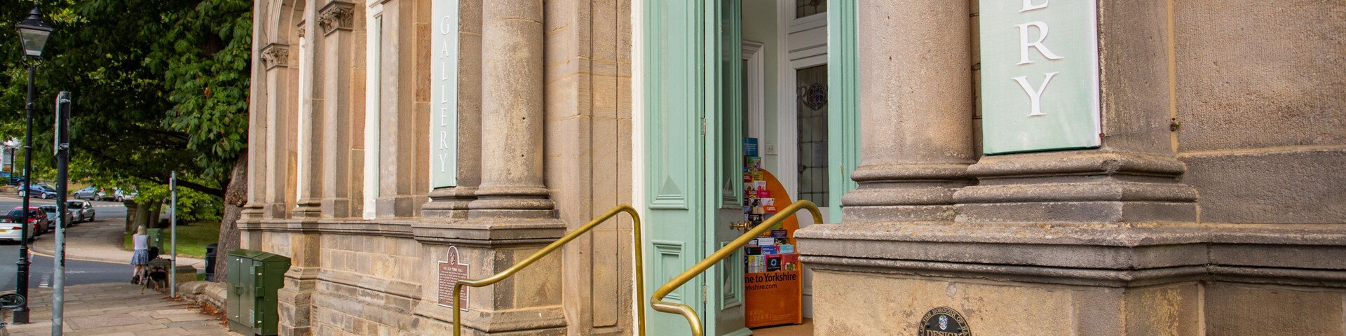 A historic building with a green door labeled "MERCER ART GALLERY".