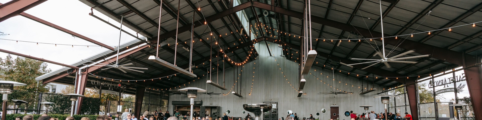 Saint Arnold Brewery showing outdoor eating as well as a large group of people