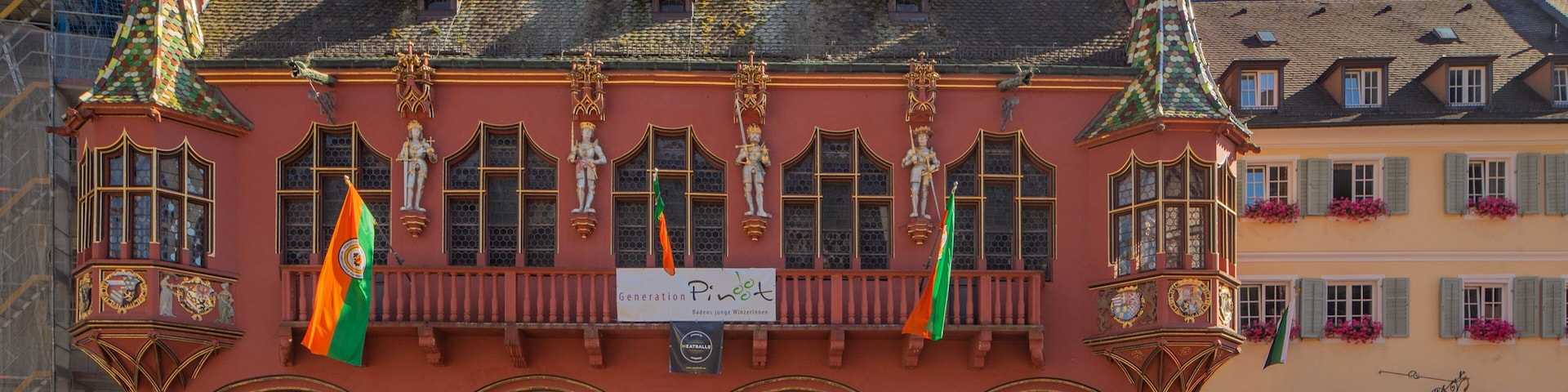 Historical Merchants\' Hall featuring heritage elements and outdoor eating as well as a large group of people