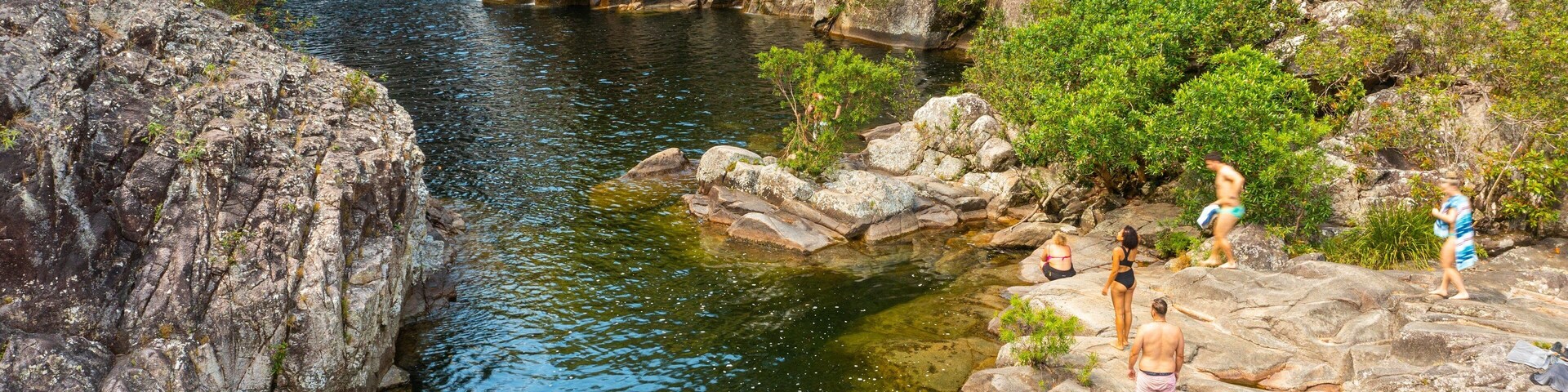 Behana Gorge which includes a cascade and a river or creek as well as a small group of people