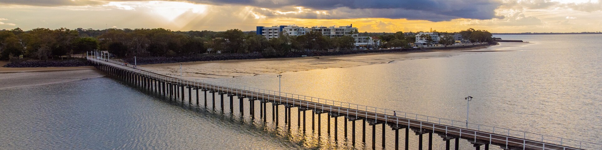 Urangan Pier which includes a bridge, landscape views and general coastal views