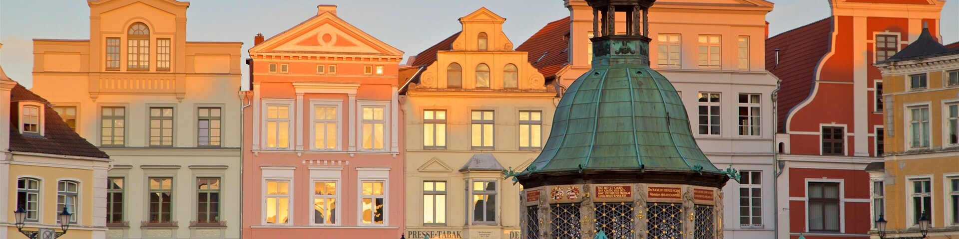 Wasserkunst featuring a city, a sunset and heritage elements