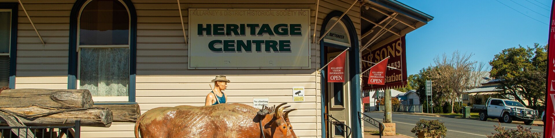 Killarney Heritage Centre featuring outdoor art, signage and a small town or village