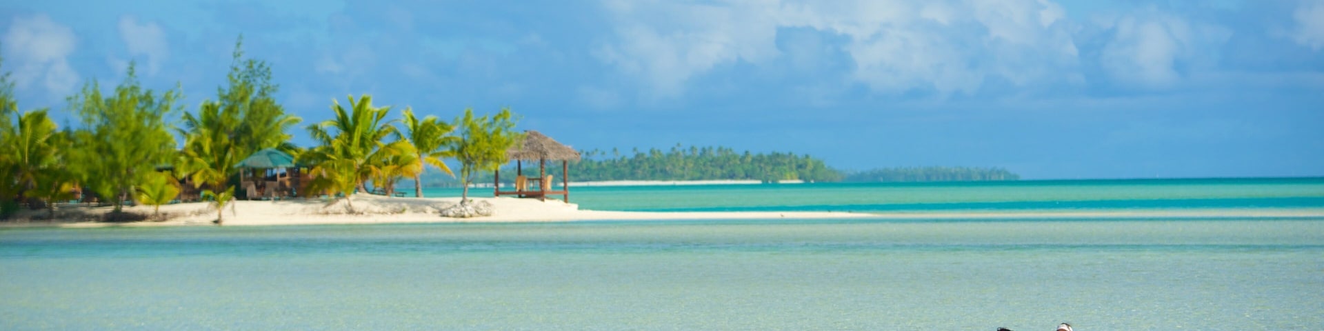Aitutaki showing general coastal views as well as a small group of people