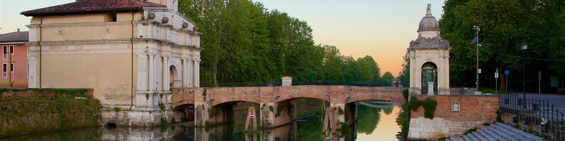 Porta Ognissanti mostrando um pôr do sol, uma ponte e um rio ou córrego
