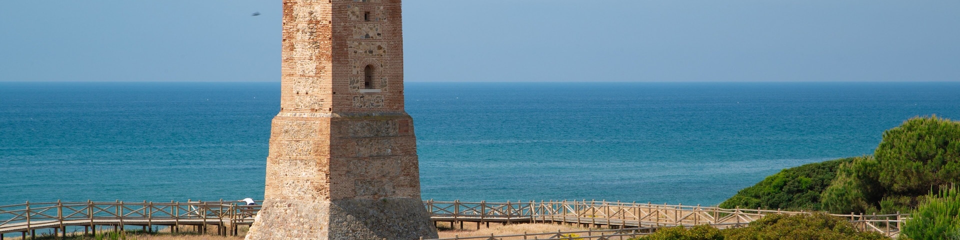 Cabopino Beach which includes general coastal views and heritage architecture