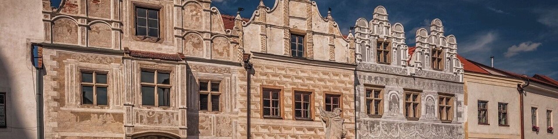 August 2017
Burgher houses, Slavonice, Czech republic
Slavonice is small town on the border of Moravia, South Bohemia and Austria. Its distance from other places preserved its medieval Renaissance city centre look through centuries to date.
Its heyday was in 14th to 16th centuries when it was an important town on the route from Prague to Vienna.
In the picture you can see two most beautiful burgher houses (Nr. 518 on the left and 517 on the right). The one on the left has actually two facades so it looks like there are three houses. They have been Gothic originally but were rebuilt in 1559 in distinguished Renaissance style. All of them have exquisite facades decorated with Sgrafitto paintings and an oriel. The houses are situated on the Upper square opposit a baroque fountain of Saint Florian built in 1783.