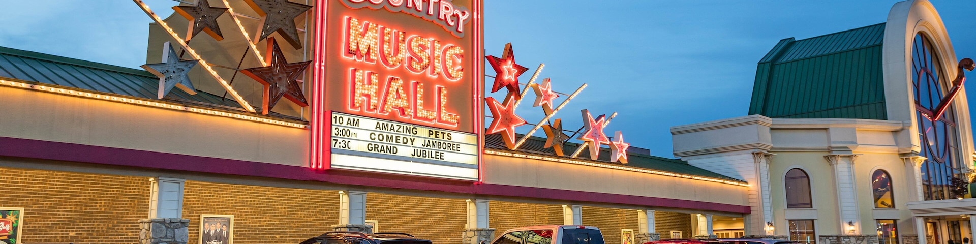 Grand Country Music Hall featuring night scenes and signage
