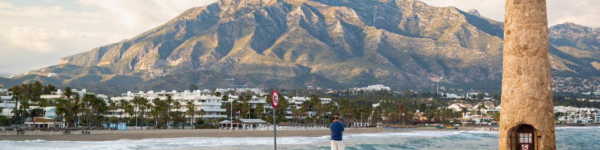 Puerto Banus Beach showing a coastal town, mountains and a lighthouse