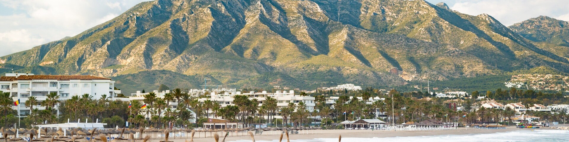Puerto Banus Beach featuring a beach, a coastal town and mountains